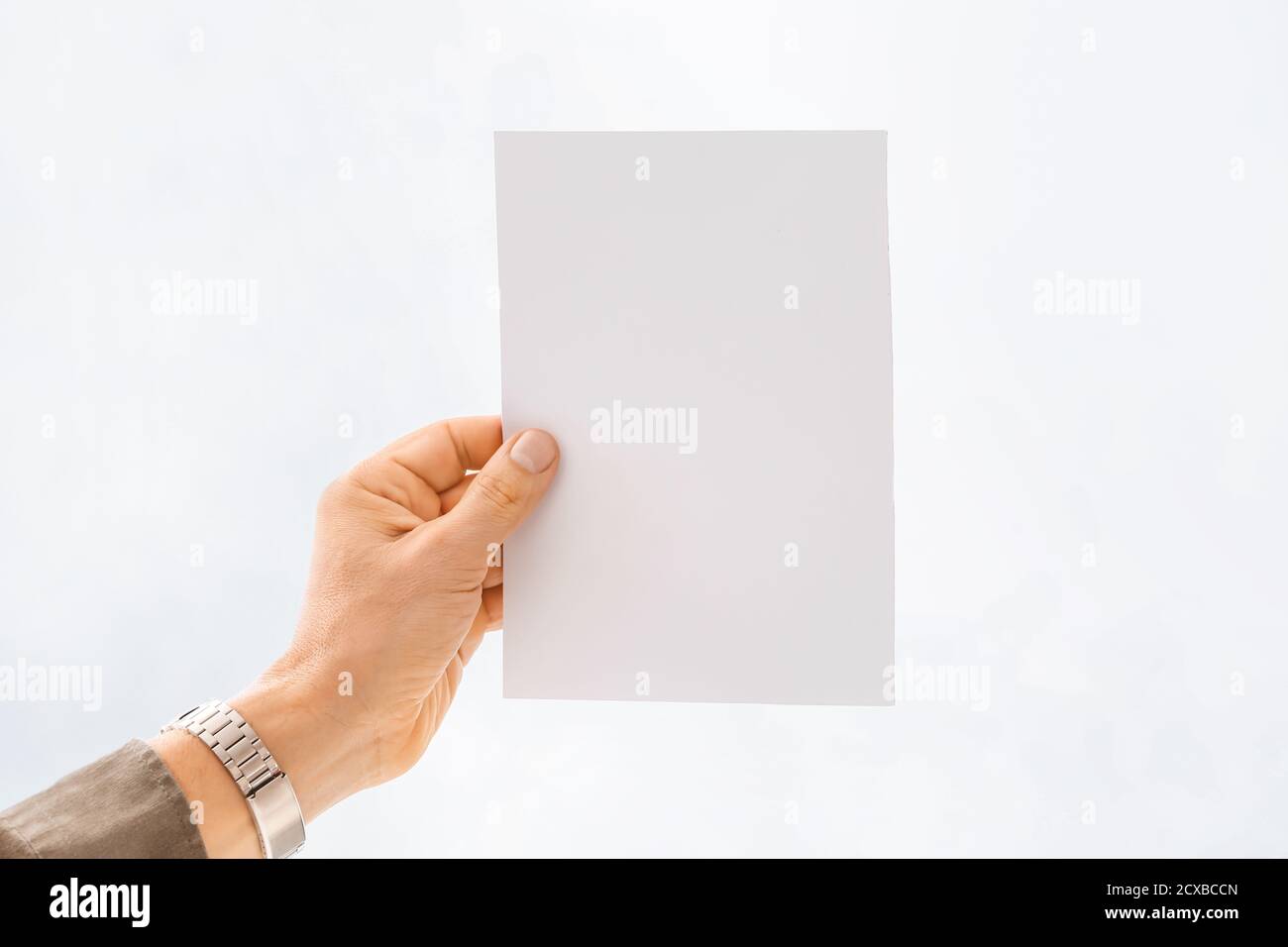 Male hand with blank paper sheet on white background Stock Photo - Alamy