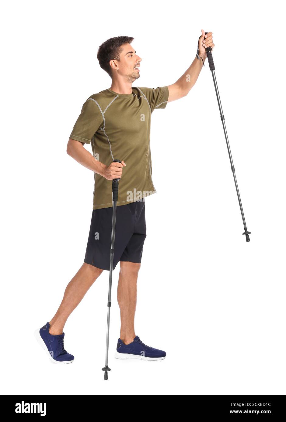 Young man with walking poles on white background Stock Photo - Alamy