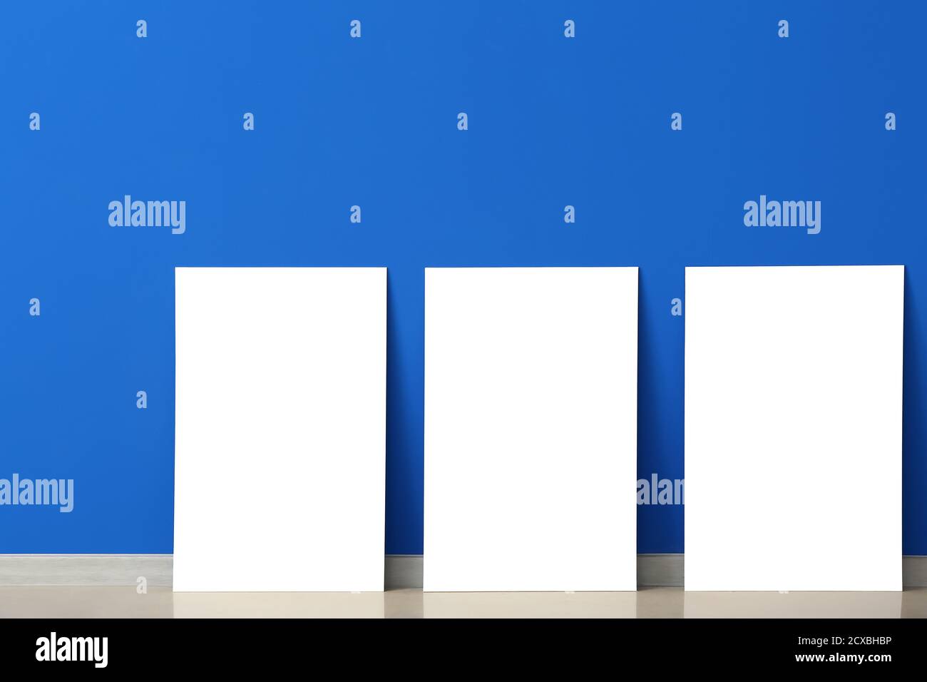 Blank posters near color wall Stock Photo - Alamy