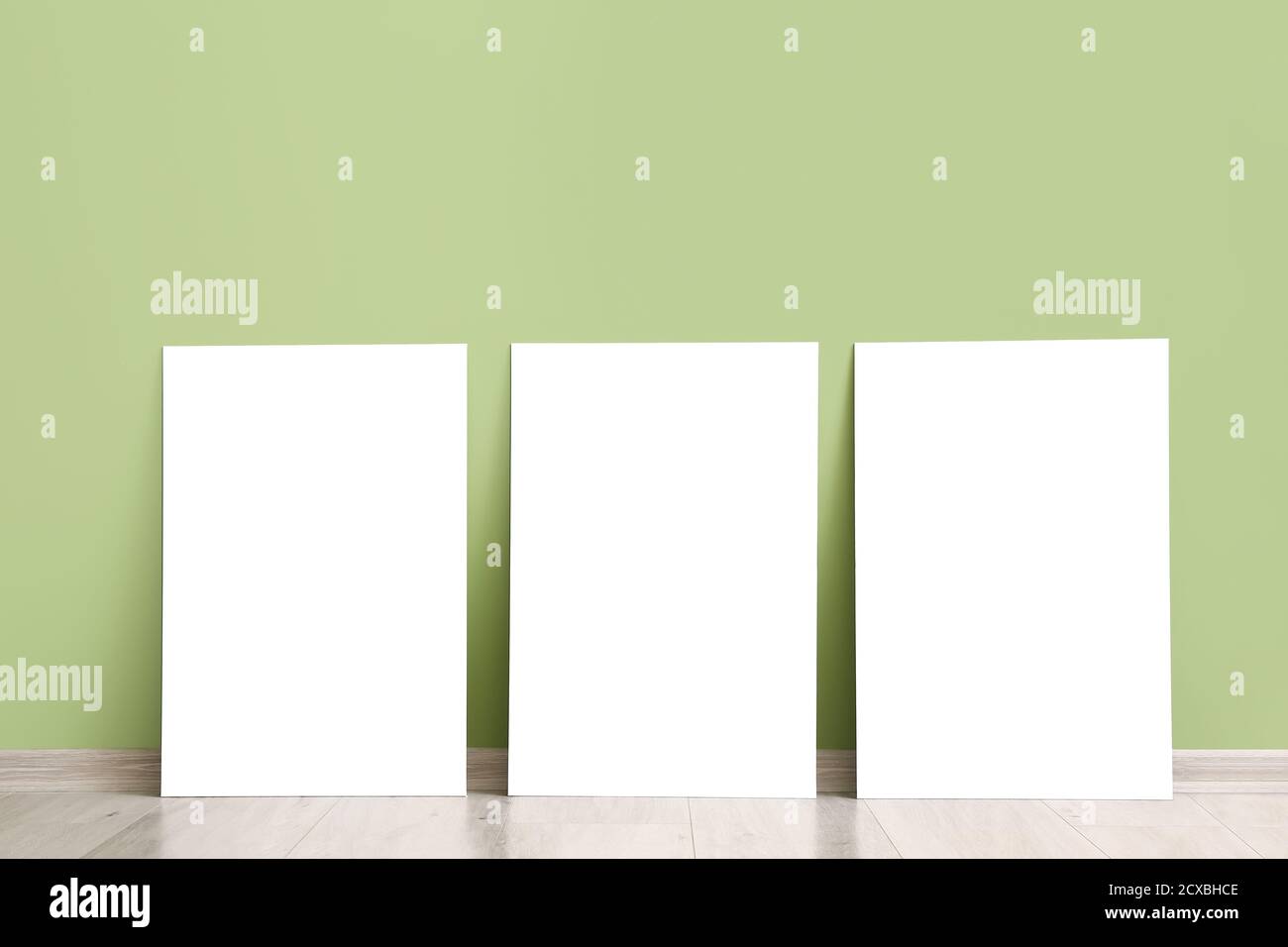 Blank posters near color wall Stock Photo - Alamy