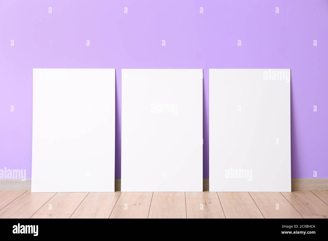 Blank posters near color wall Stock Photo - Alamy