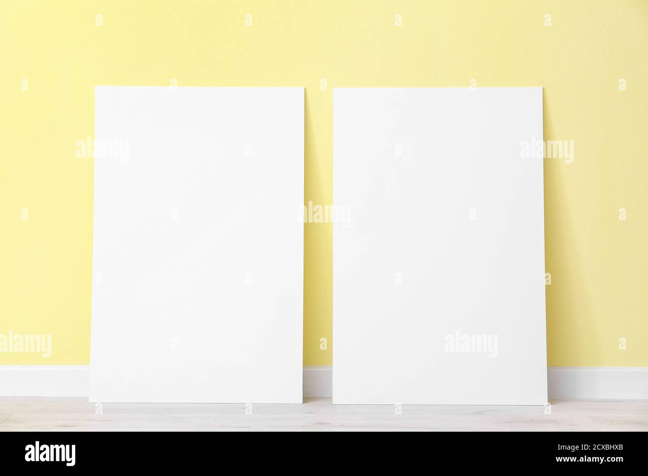 Blank posters near color wall Stock Photo - Alamy