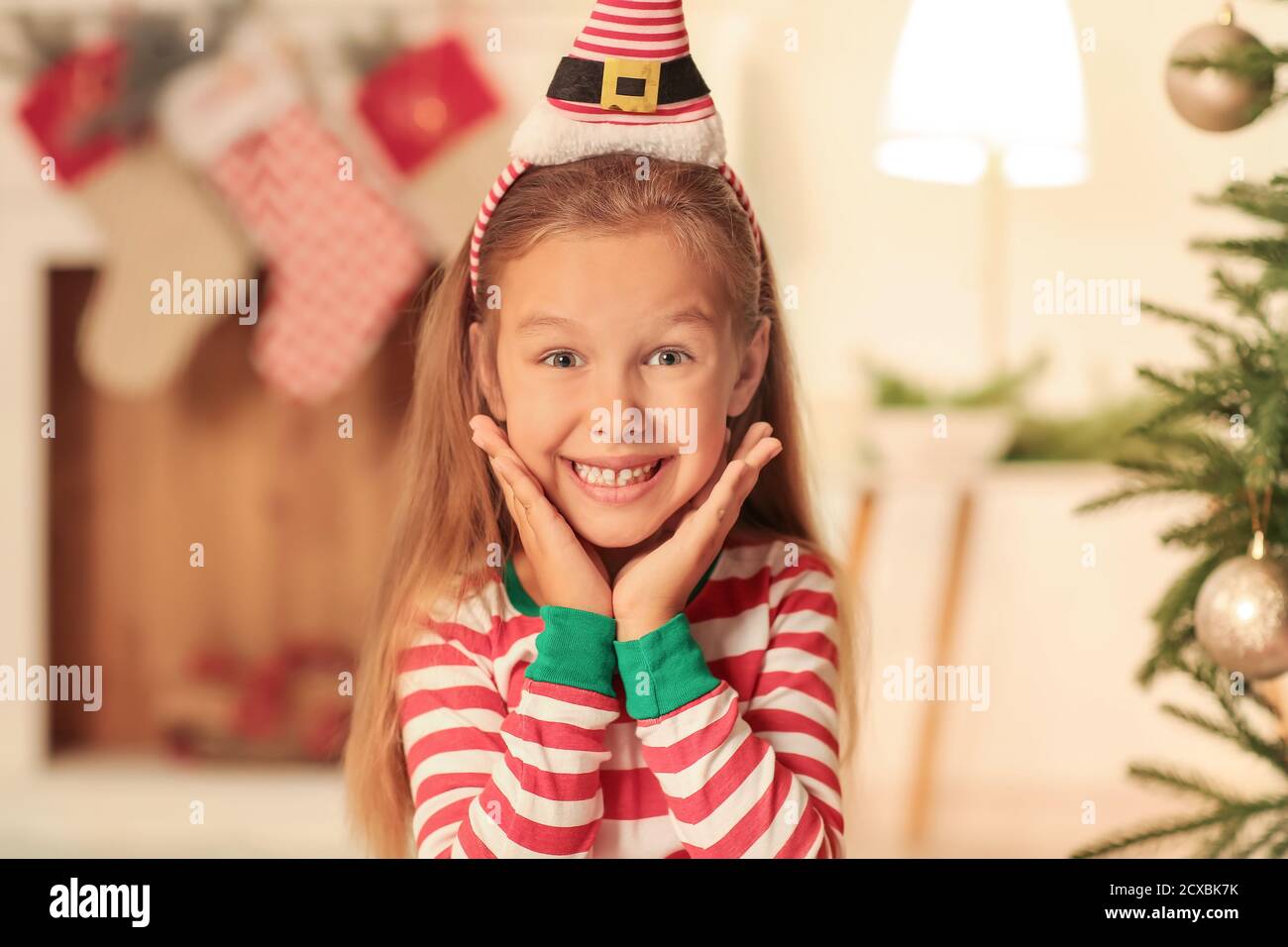 Happy little girl at home on Christmas eve Stock Photo - Alamy