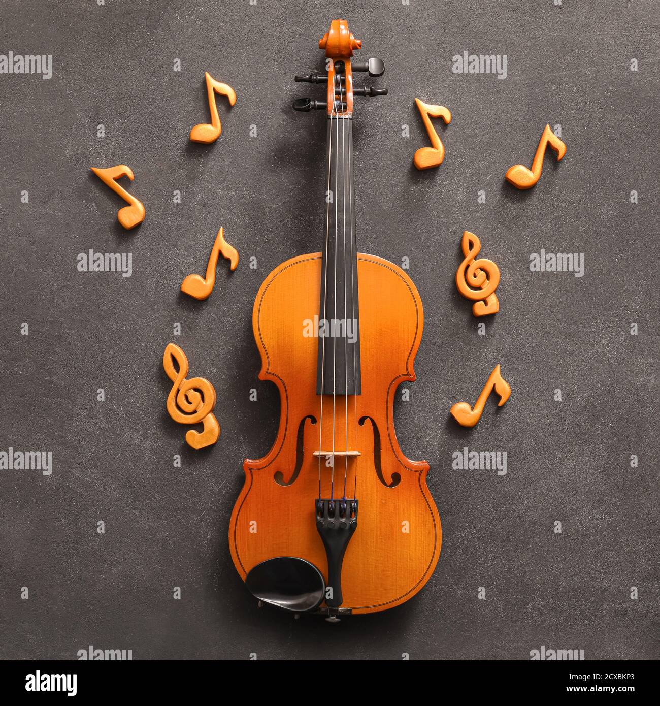 Violin with music notes on dark background Stock Photo - Alamy