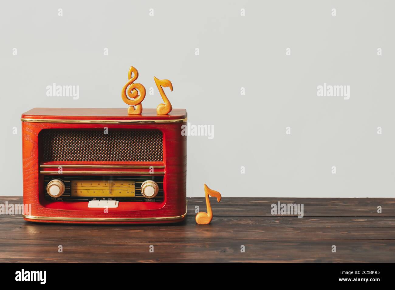 Vintage radio receiver with music notes on table Stock Photo - Alamy