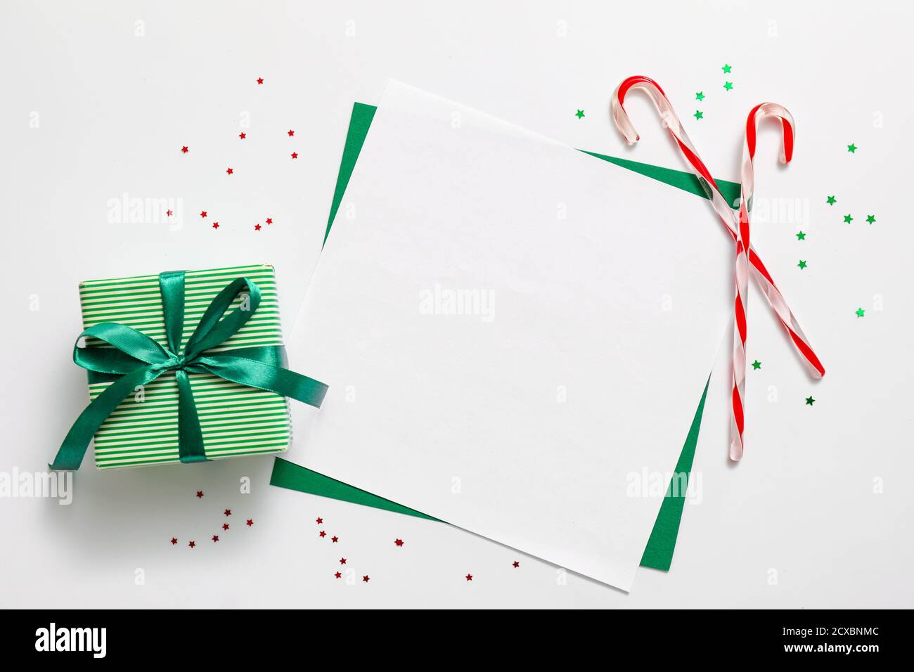 Beautiful Christmas gift with empty card on white background Stock ...