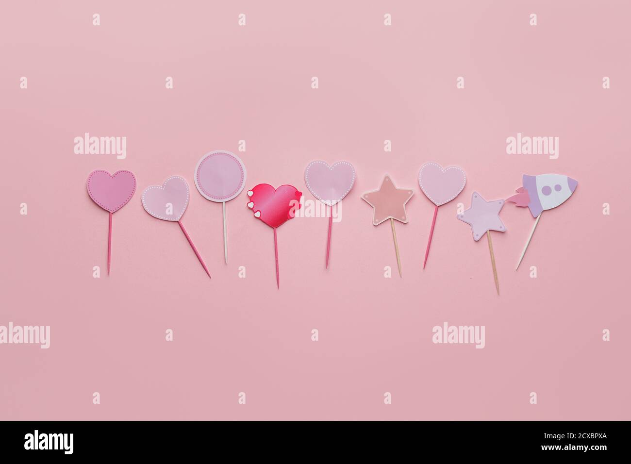 Stylish cupcake toppers on color background Stock Photo - Alamy