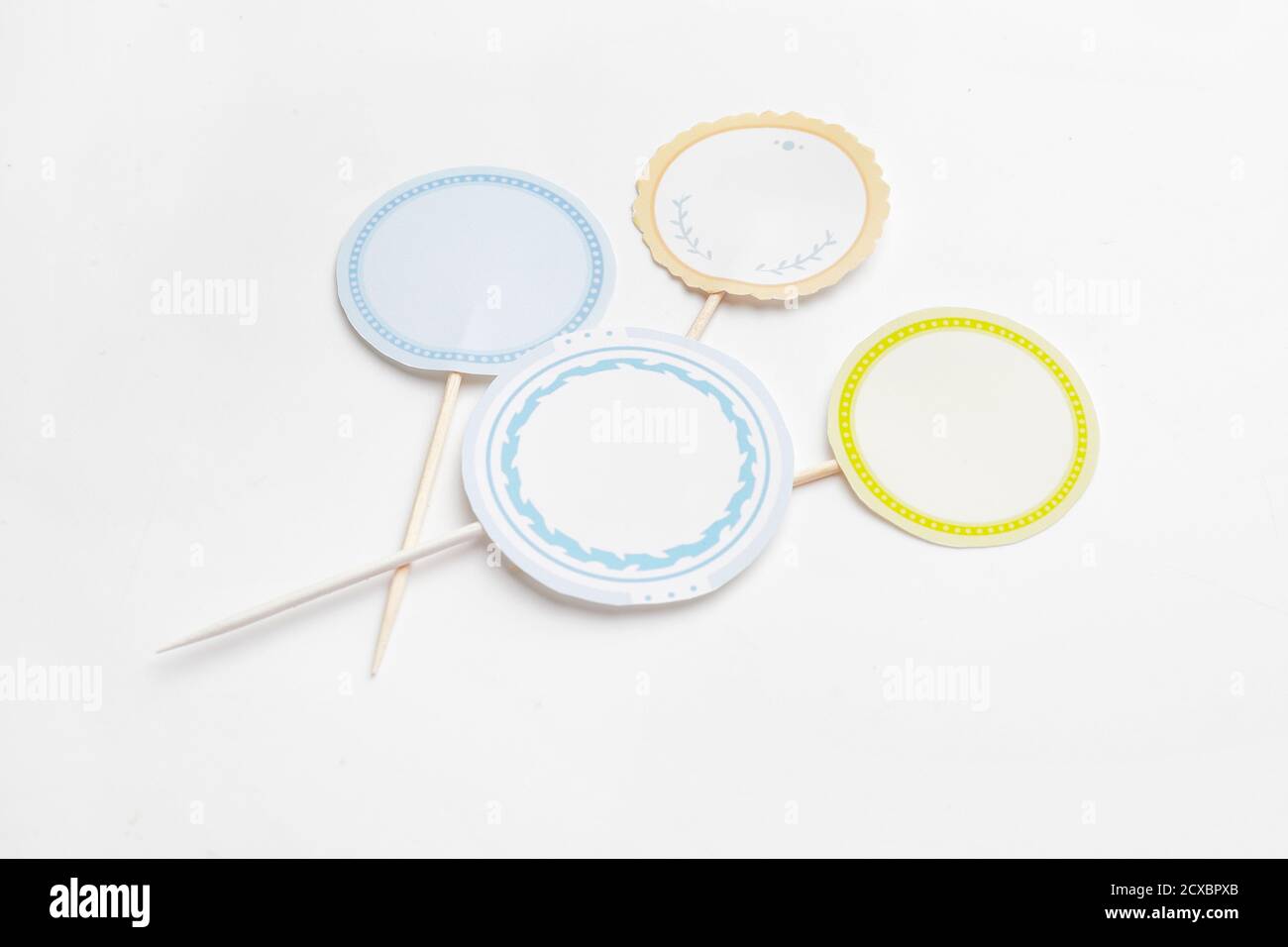 Stylish cupcake toppers on white background Stock Photo - Alamy