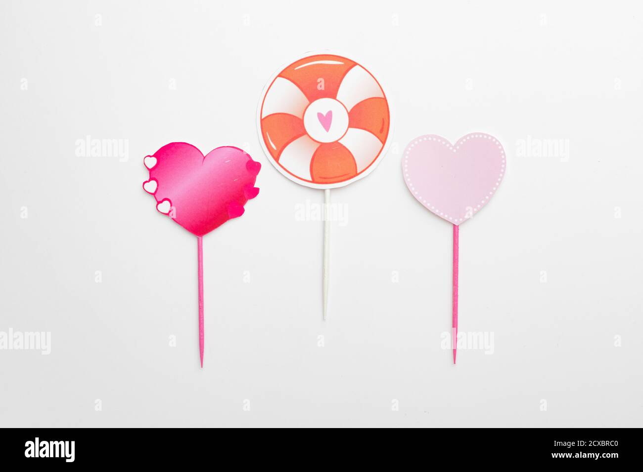 Stylish cupcake toppers on white background Stock Photo - Alamy