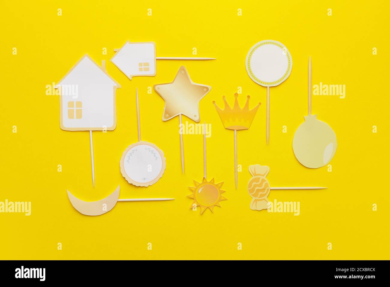 Stylish cupcake toppers on color background Stock Photo - Alamy