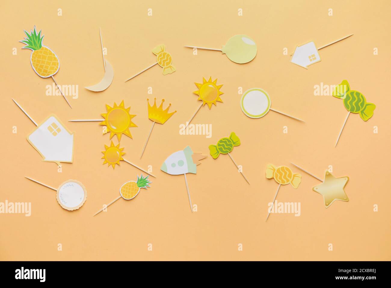 Stylish cupcake toppers on color background Stock Photo - Alamy