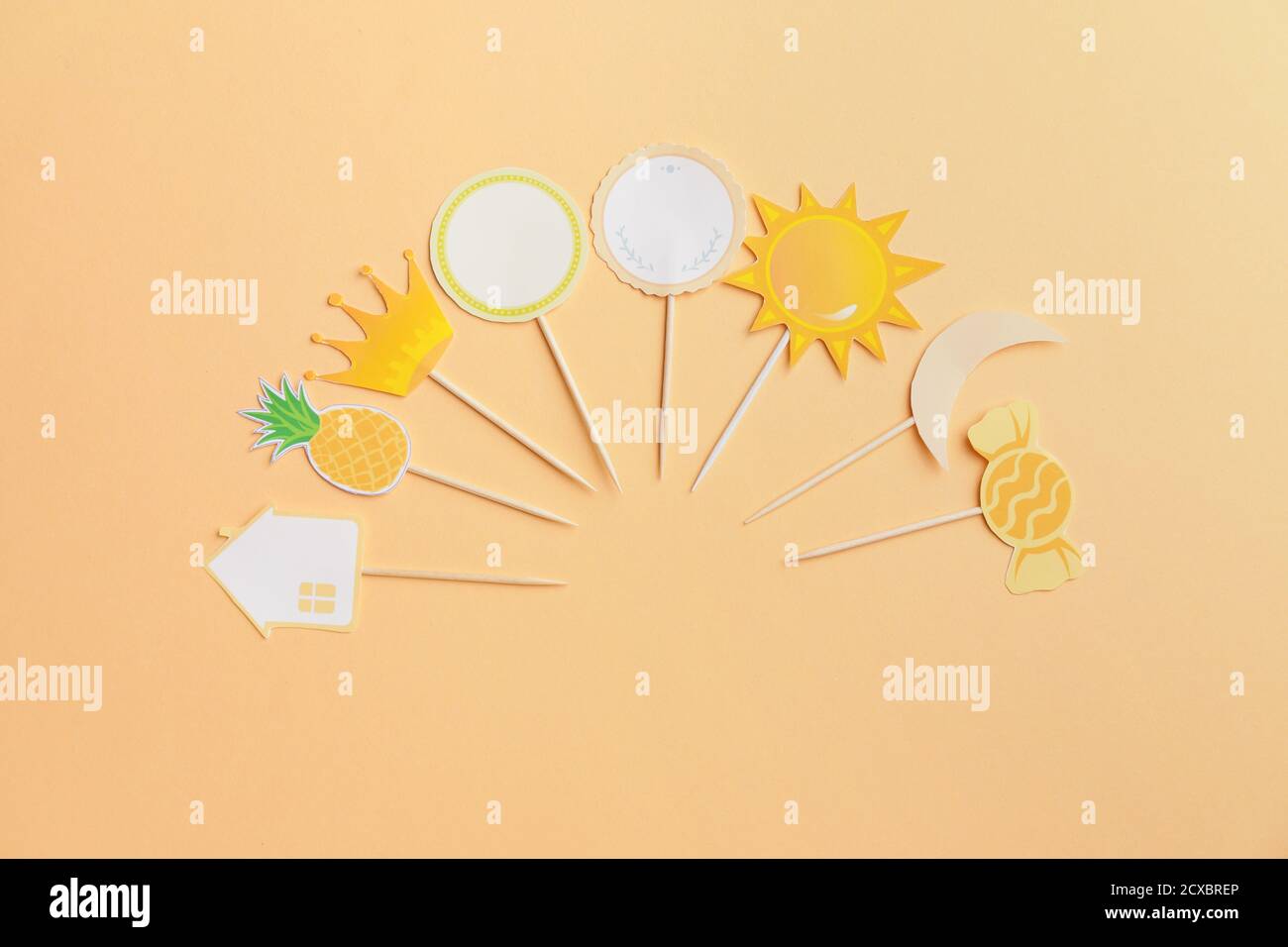 Stylish cupcake toppers on color background Stock Photo - Alamy