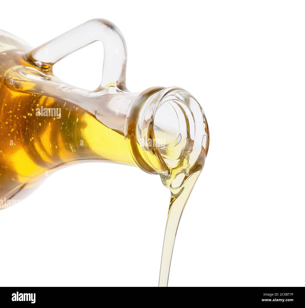 Pouring of fresh olive oil from bottle on white background Stock Photo ...