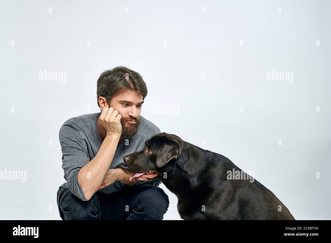 happy owner with pet black dog training model emotions Stock Photo - Alamy