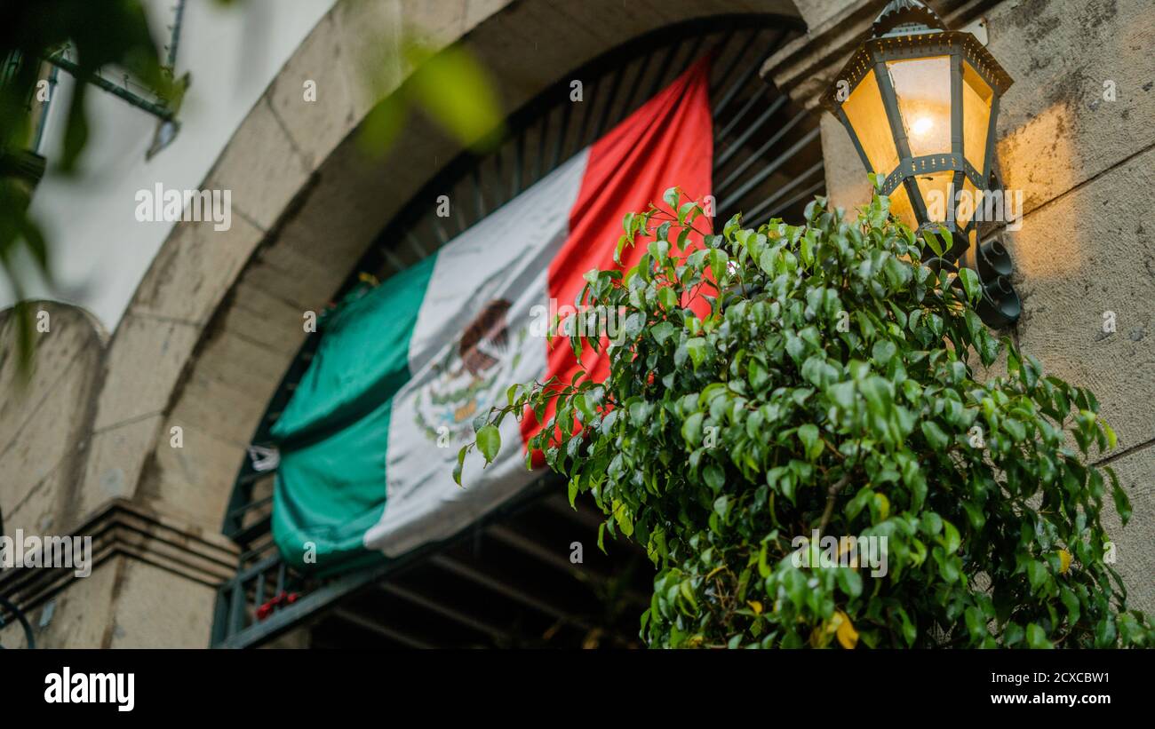 Mexican Flag Hanging Over a Building Arched Entrance Stock Photo - Alamy