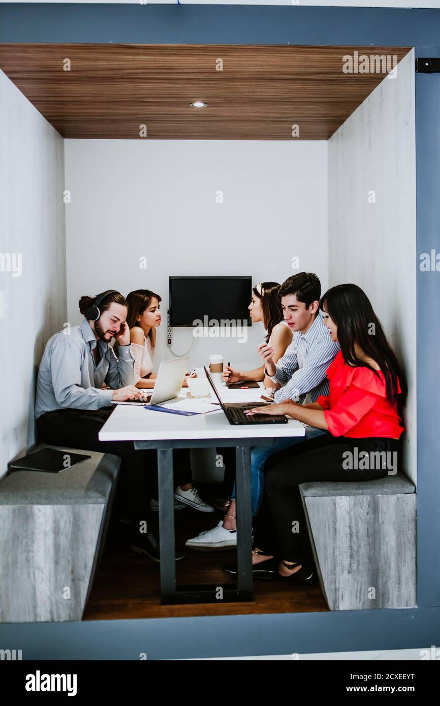 Latin people or office workers using computer and discuss about ...