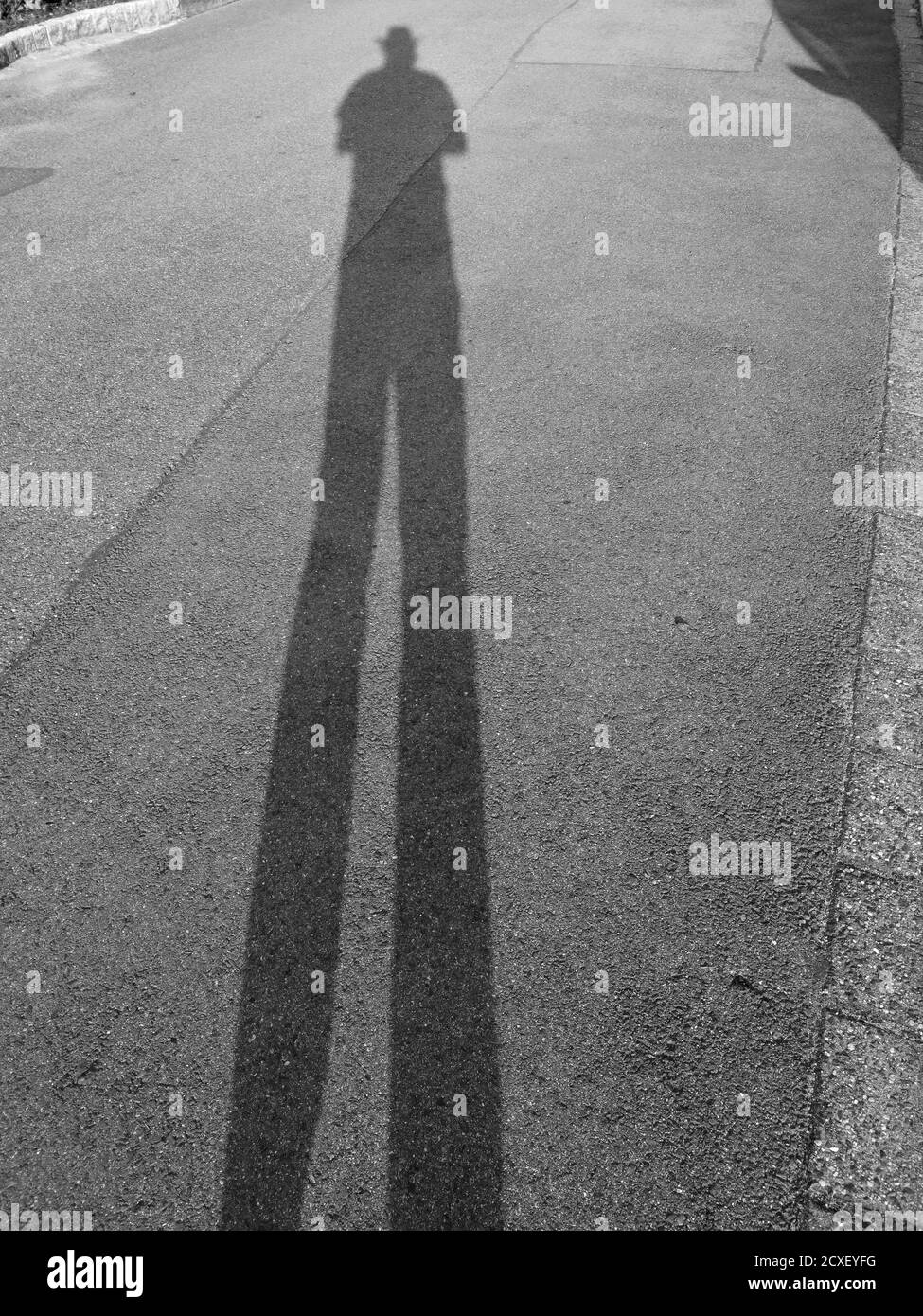 Vertical shot of human shadow on a gray concrete surface Stock Photo ...