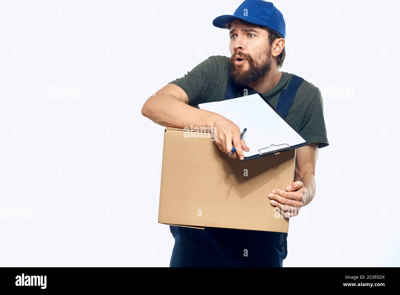 Man in working uniform box delivery loader courier light background ...