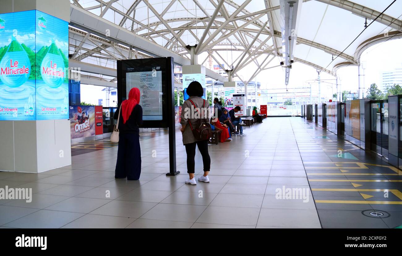 Jakarta, Indonesia - November 11, 2019: Train passengers read of the ...
