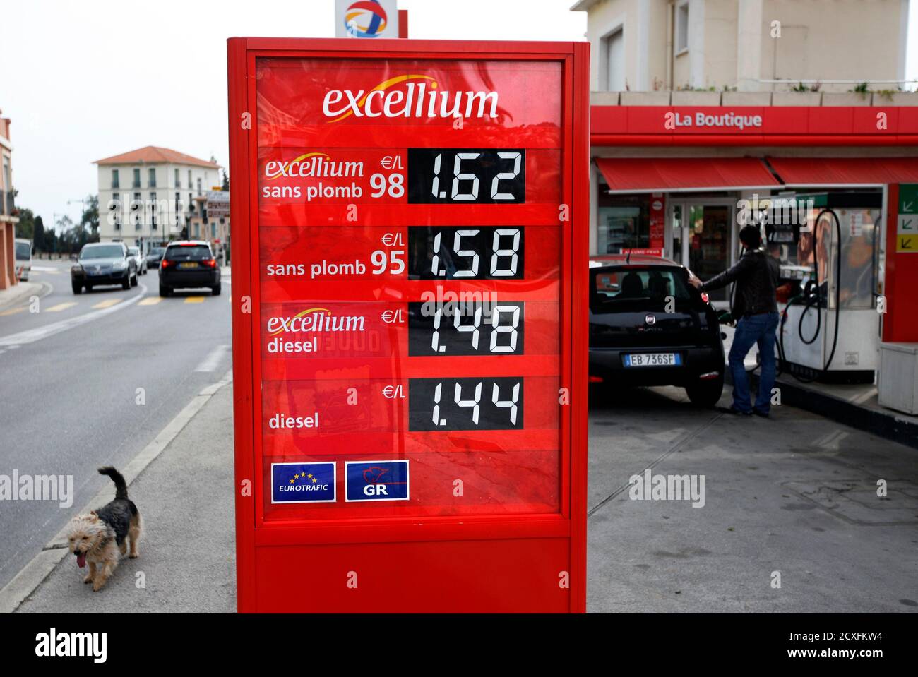 Customer fills her car with petrol at petrol station hi-res stock ...