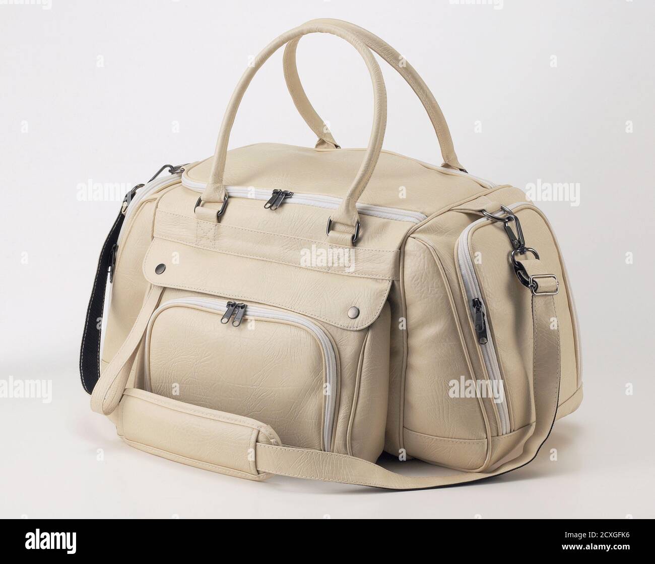 Leather beige travel bag on white background Stock Photo - Alamy