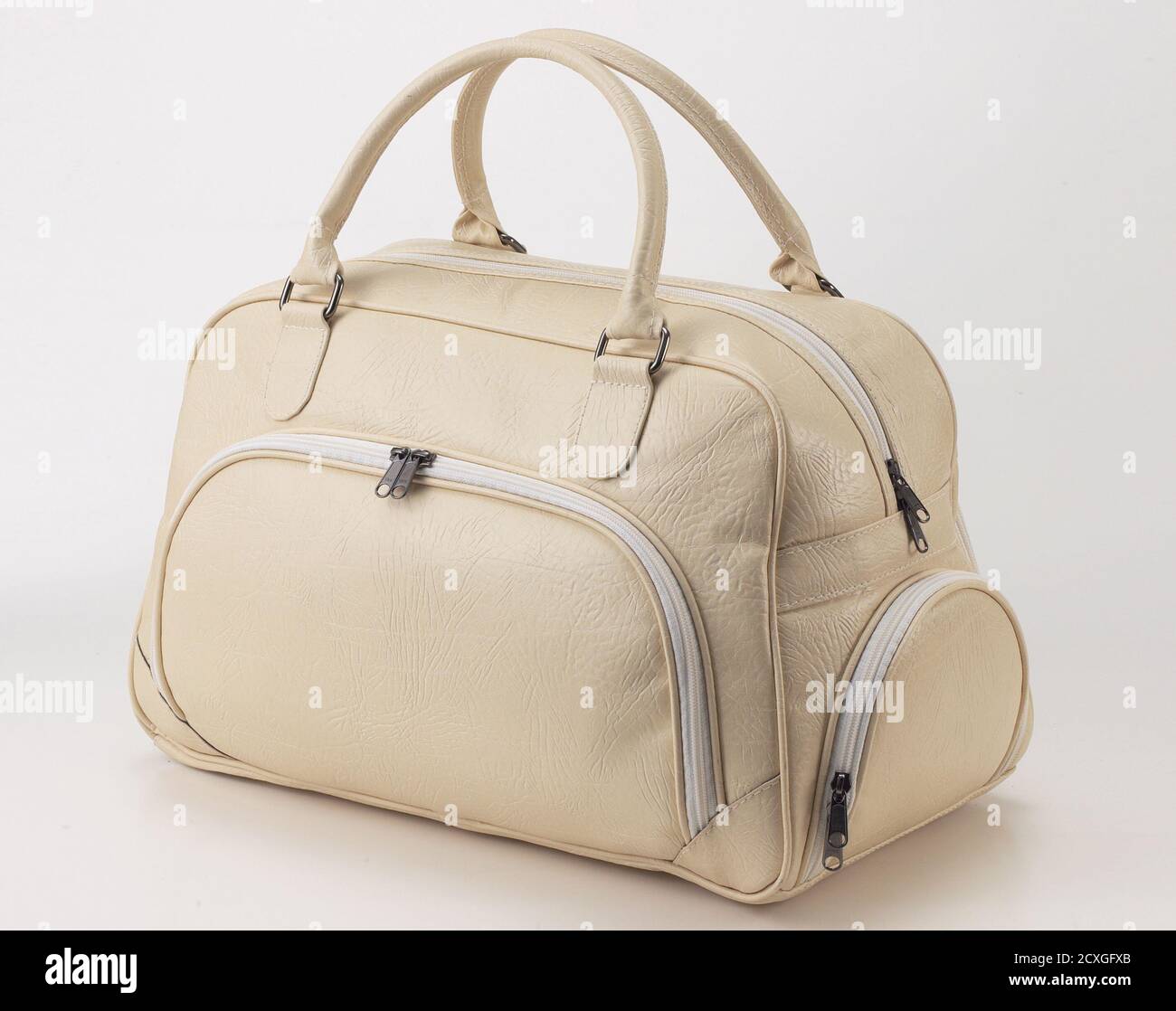 Leather beige travel bag on white background Stock Photo - Alamy