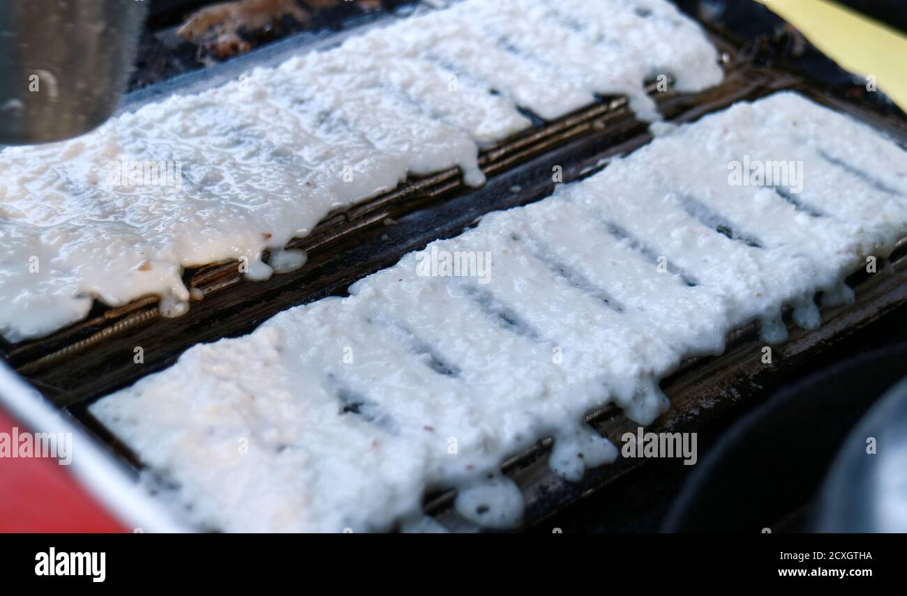 Cooking Pancong cake or kue pancong Stock Photo - Alamy