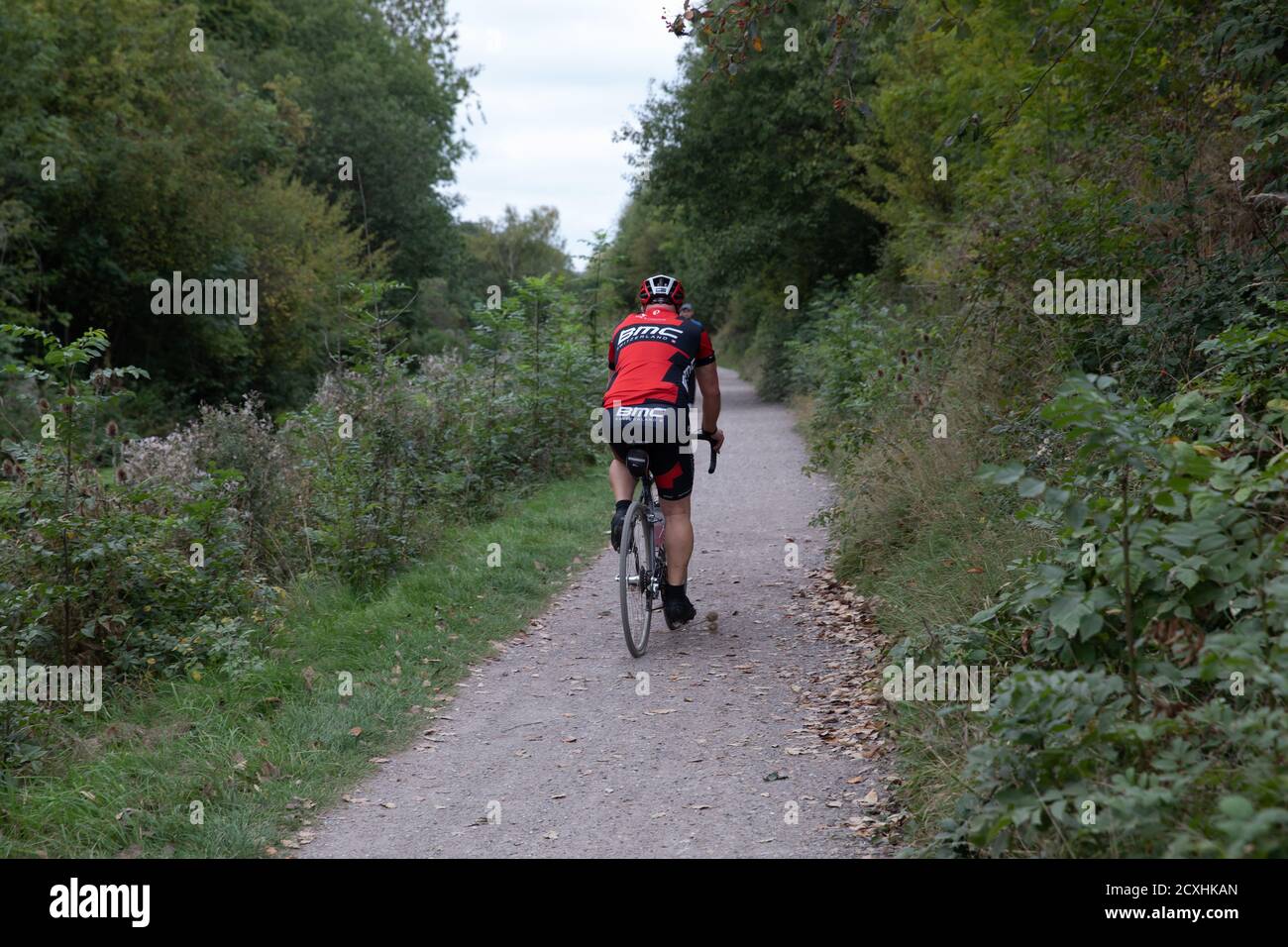 A cyclist rides along on the tow path by Chesterfield Canal on a dull ...