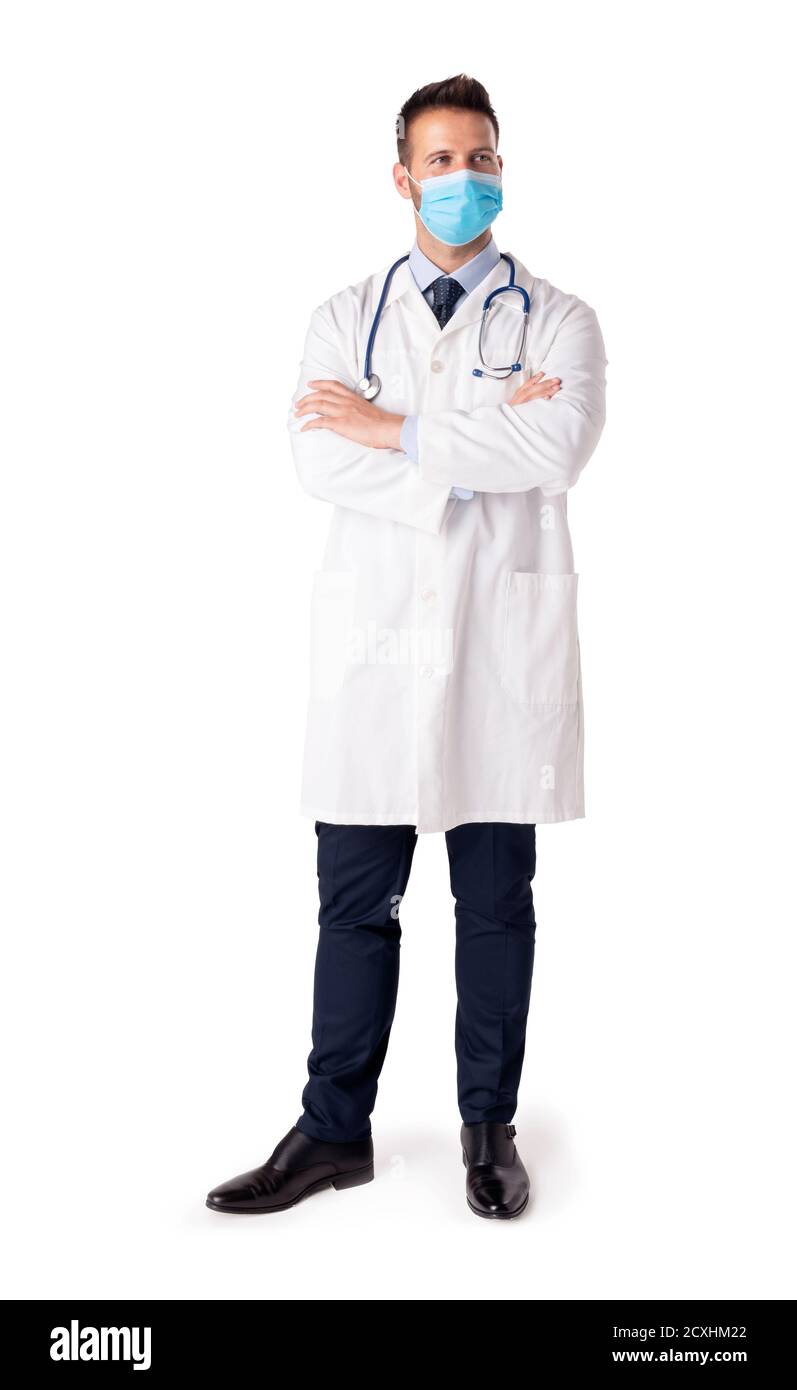 Full length shot of male doctor wearing face mask while standing at ...
