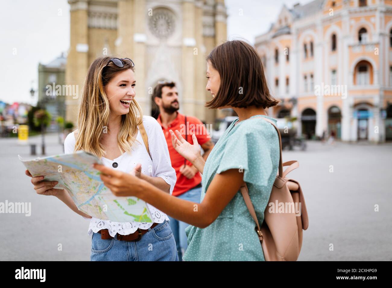 Holidays, travel, friends and tourism concept. Beautiful girls looking ...