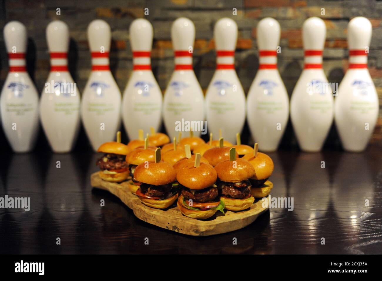 Luxury or Deluxe hamburgers on a serving tray at a bowling alley. With ...