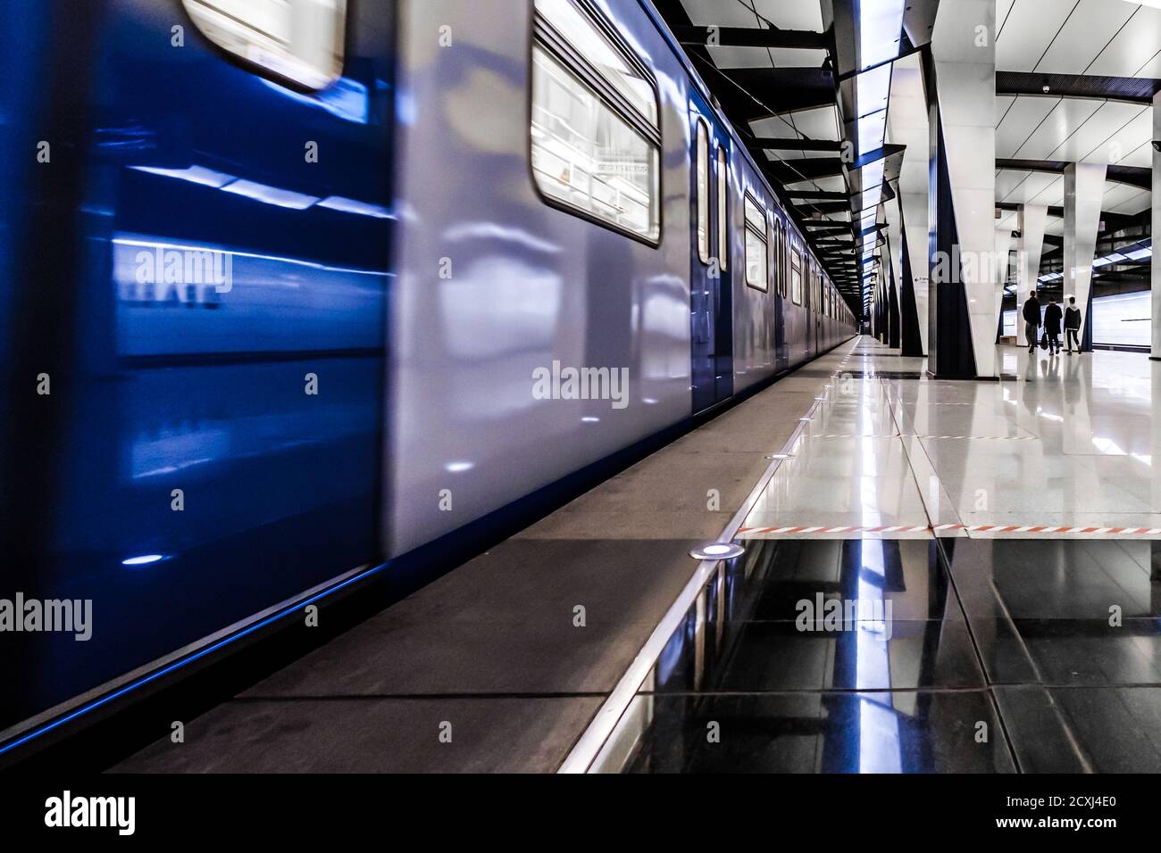 Modern metro station at night. Empty subway train cars arrive at the ...