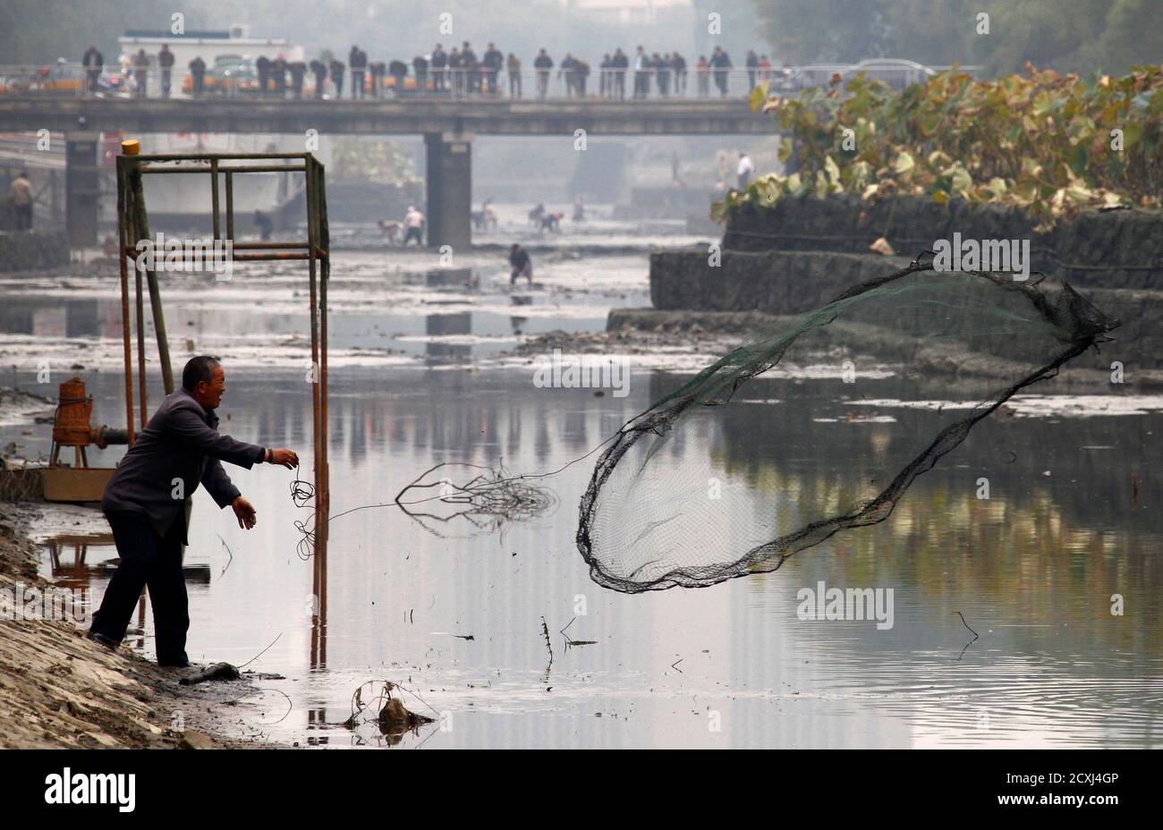 Man fishing in polluted water hi-res stock photography and images - Alamy