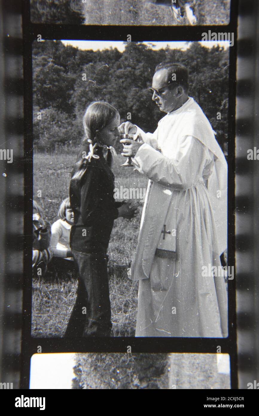 Fine 1970s vintage black and white photography of priest giving Holy ...