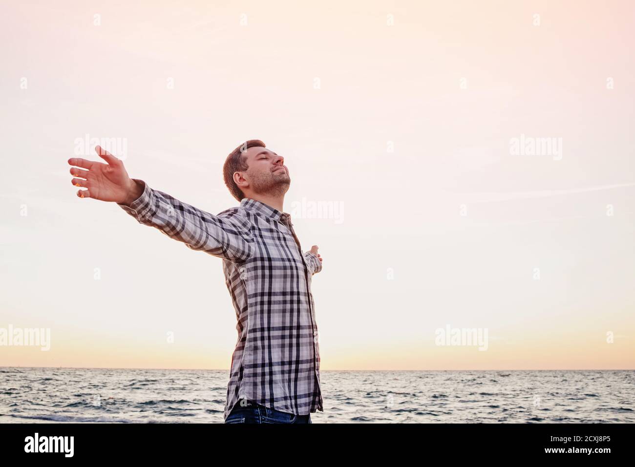 Man with arms open sun hi-res stock photography and images - Alamy
