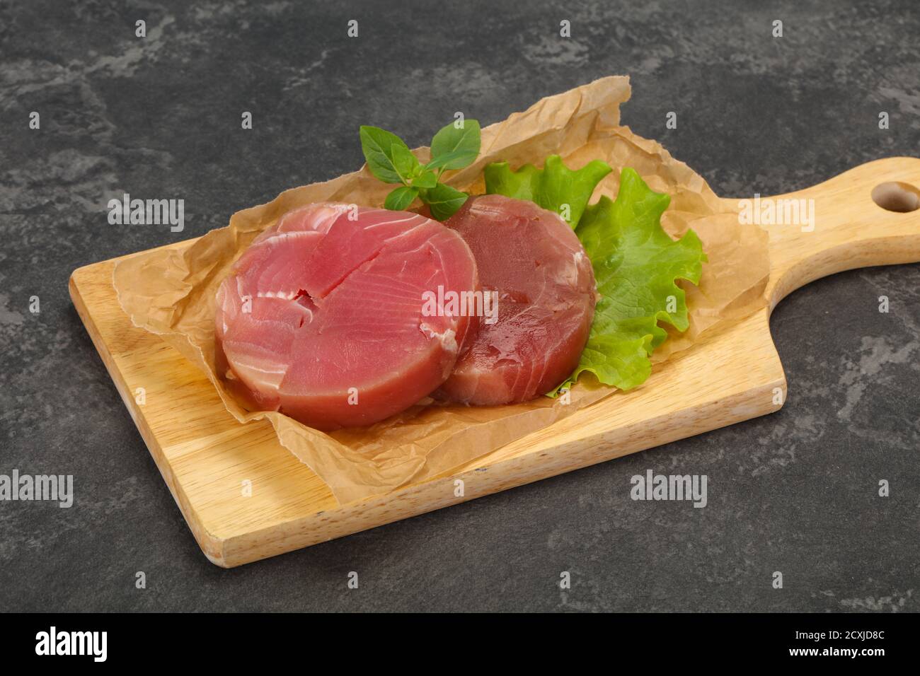 Raw tuna round steak ready for grill Stock Photo - Alamy
