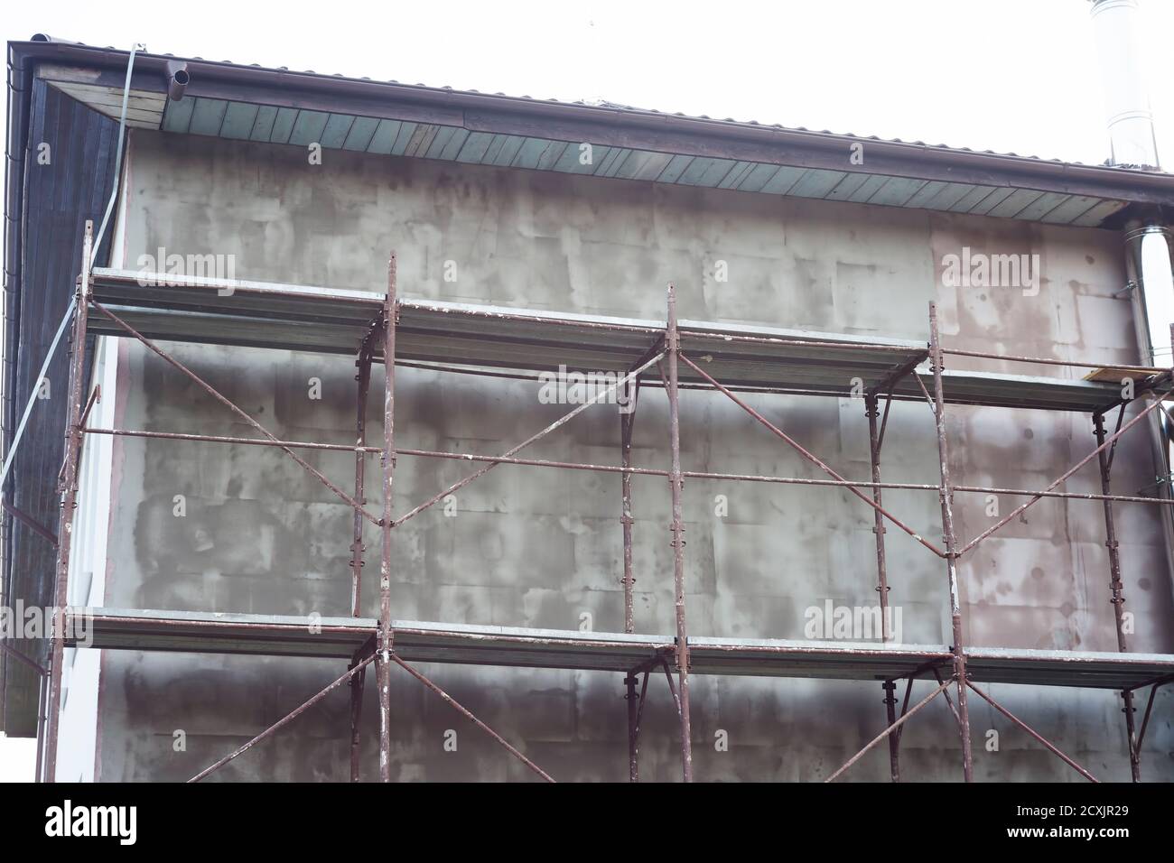 house renovation from exterior, scaffolding in construction Stock Photo ...