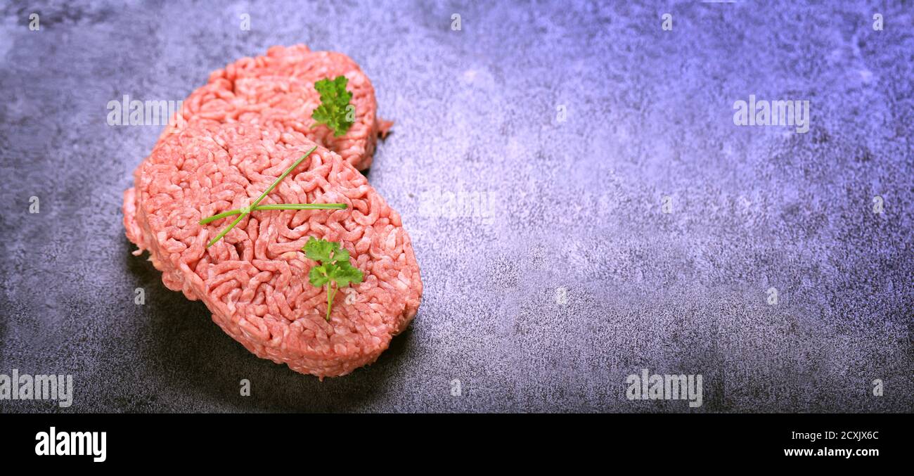 Red burger meat closeup on black background Stock Photo - Alamy