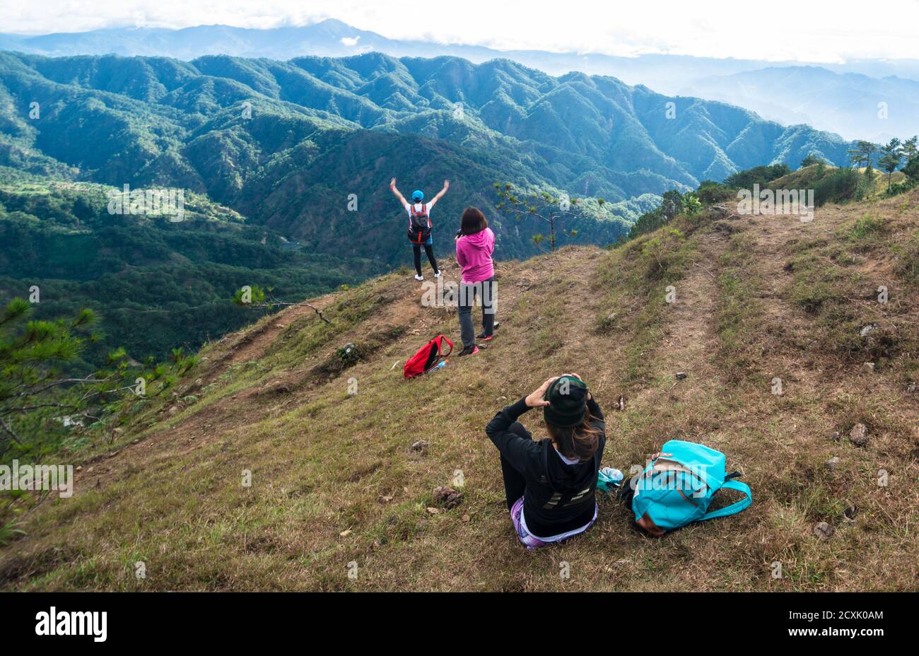 Hikers enjoying the view from the top of a mountain, Mt. Ulap, Benguet ...