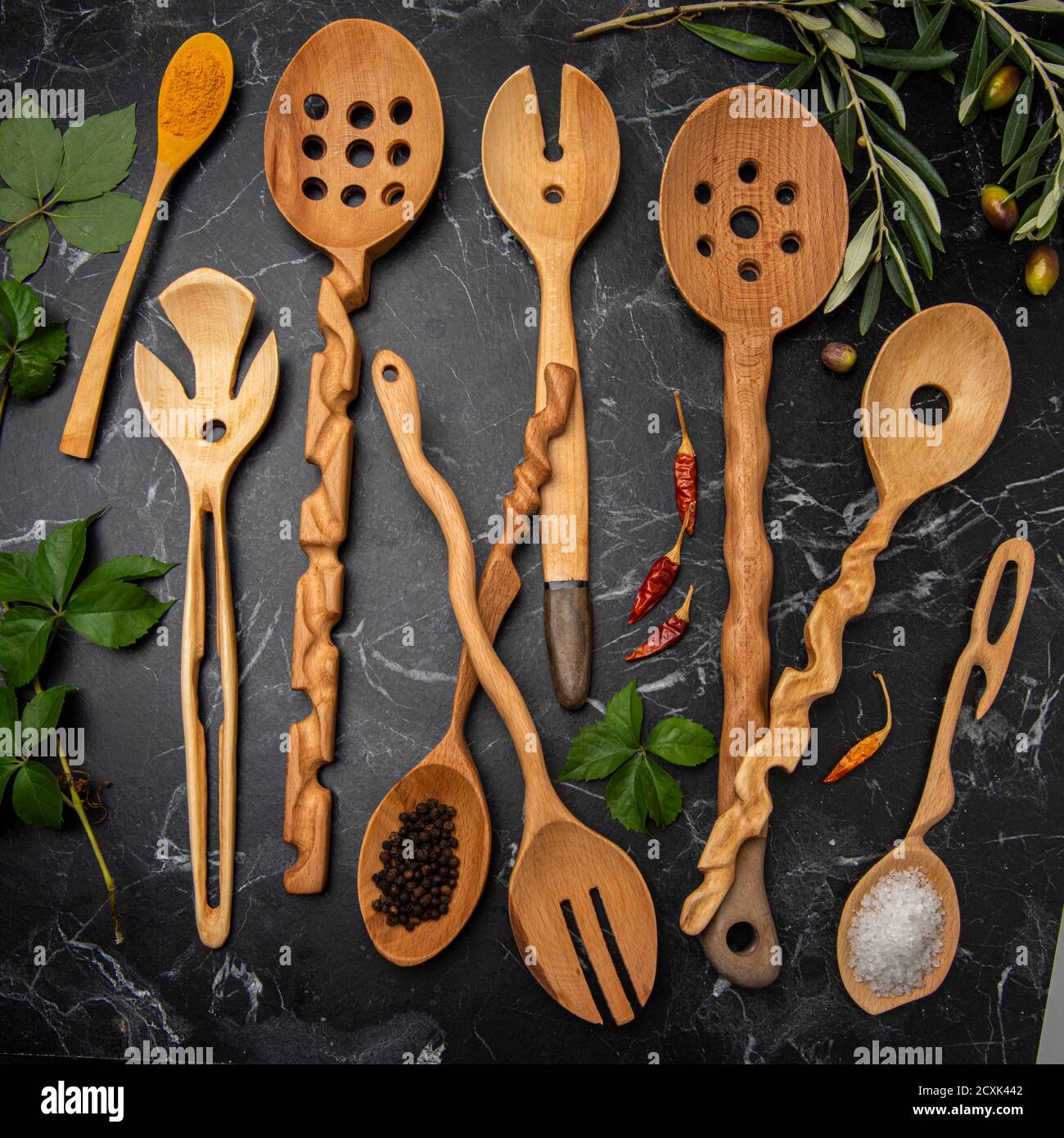 handmade wooden kitchen tools on black marble Stock Photo - Alamy