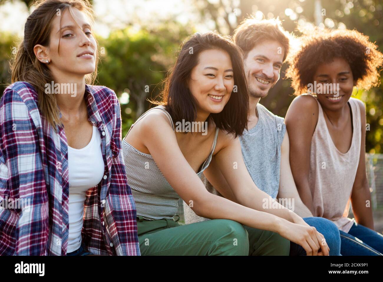 Three friends sitting park hi-res stock photography and images - Alamy