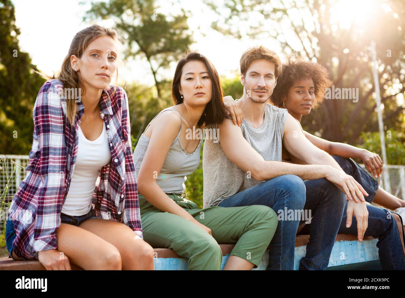 Three friends sitting park hi-res stock photography and images - Alamy