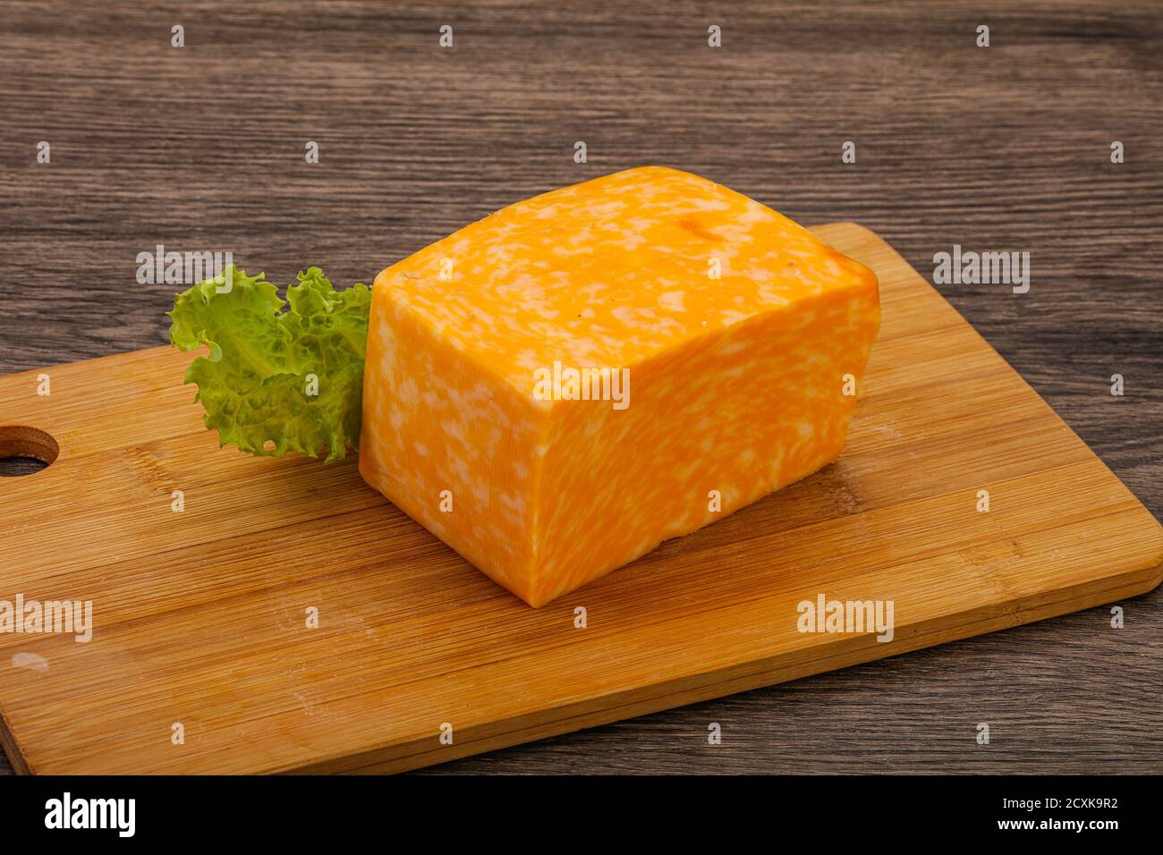 Dairy Marble cheese brick over board Stock Photo - Alamy