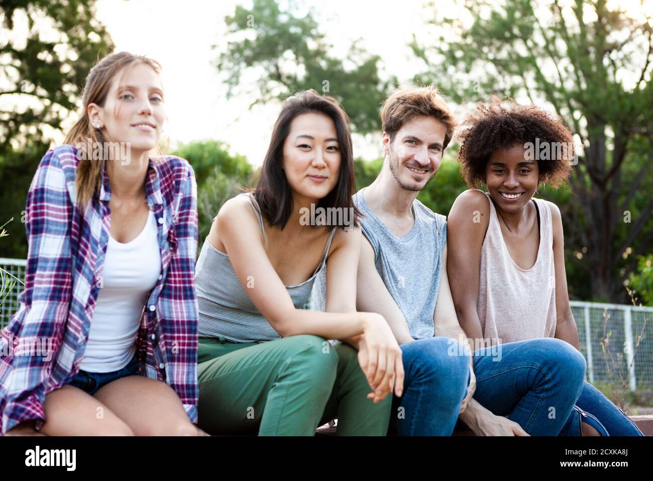 Three friends sitting park hi-res stock photography and images - Alamy