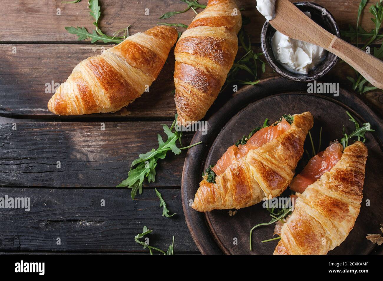 Croissant with smoked salted salmon, spinach and arugula served with ...