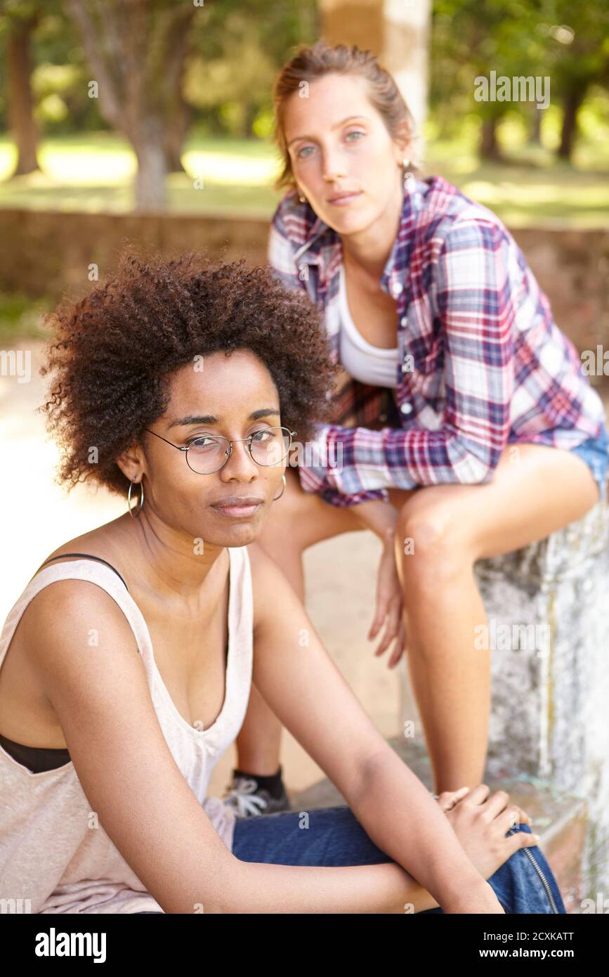 Beautiful young women sitting outdoors Stock Photo - Alamy