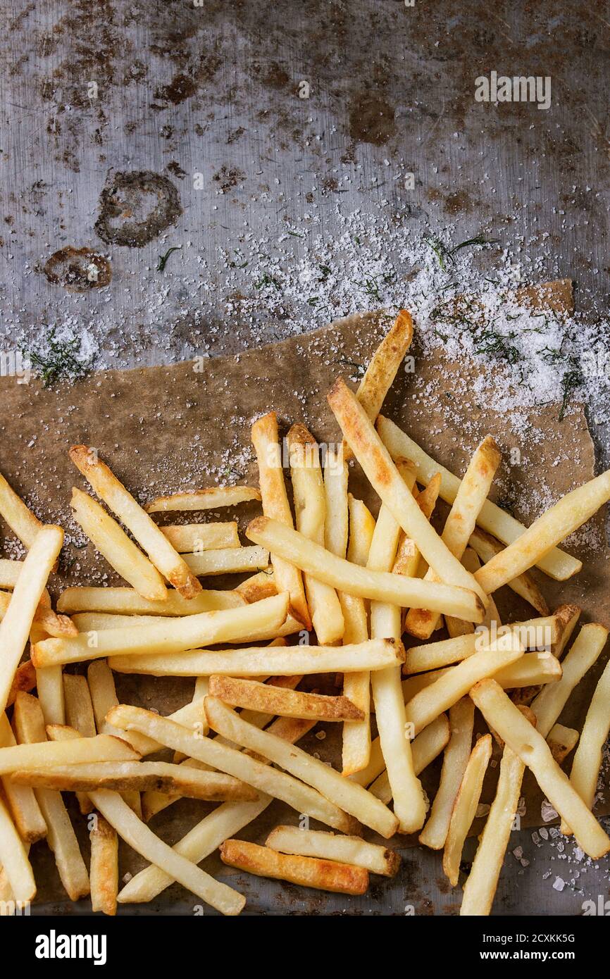 Fast food french fries potatoes with skin served with salt and herbs on ...