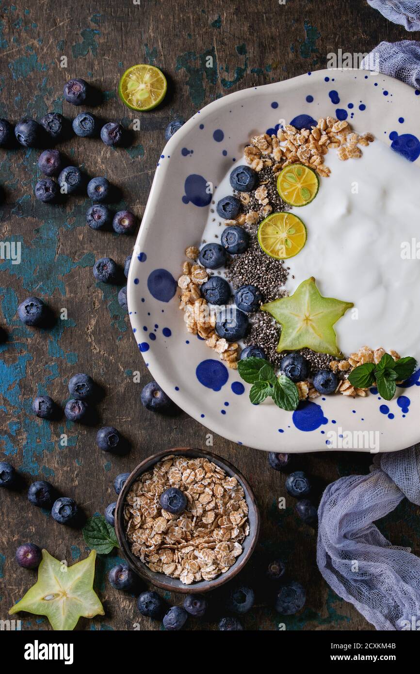 Smoothie bowl healthy breakfast. Yogurt with blueberries, granola, chia ...