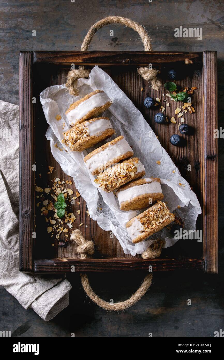 Set of homemade ice cream sandwiches in oat cookies with almond sugar ...