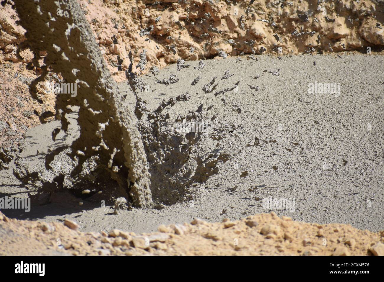 Cement Splashing into Hole Stock Photo - Alamy